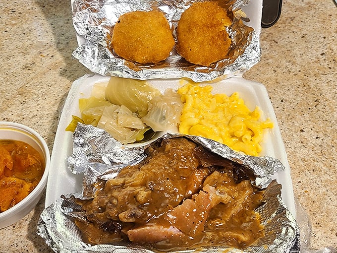 Smothered pork chops swimming in gravy with cabbage and mac and cheese—comfort food that hugs you from the inside out. 