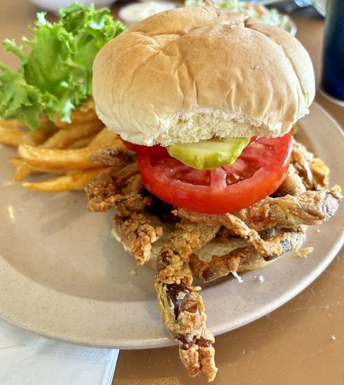 The soft-shell crab sandwich—where the entire crustacean gets the deep-fried treatment before lounging on a bun with tomato and pickle roommates.