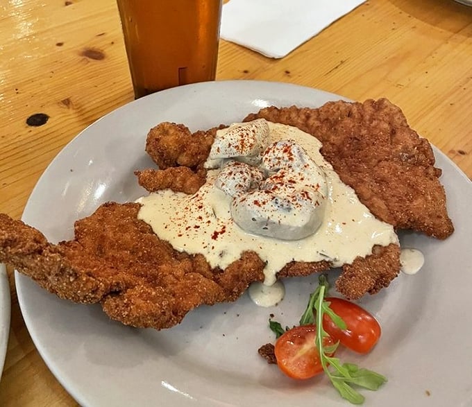 Not your average schnitzel! This beauty wears a dollop of sour cream like a crown – royalty on a plate.