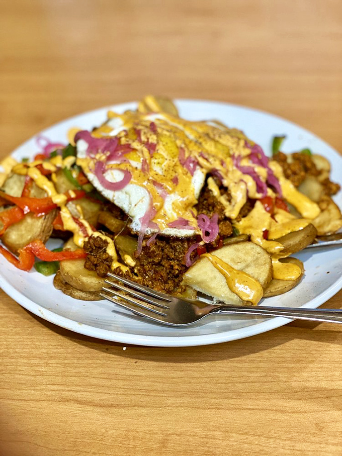 This loaded hash creation looks like what would happen if breakfast and dinner had a beautiful baby – topped with a sunny egg and vibrant pickled onions.
