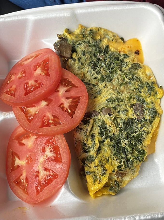 This isn't just an omelet; it's a garden wrapped in eggs, with spinach and mushrooms playing the starring roles.