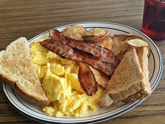The breakfast plate that launched a thousand satisfied sighs—scrambled eggs, crispy bacon, and toast ready for its butter close-up.