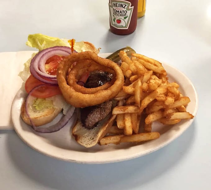 This isn't just a sandwich – it's architecture with flavor, where every layer from the crispy onion ring to the seasoned fries plays its part perfectly.