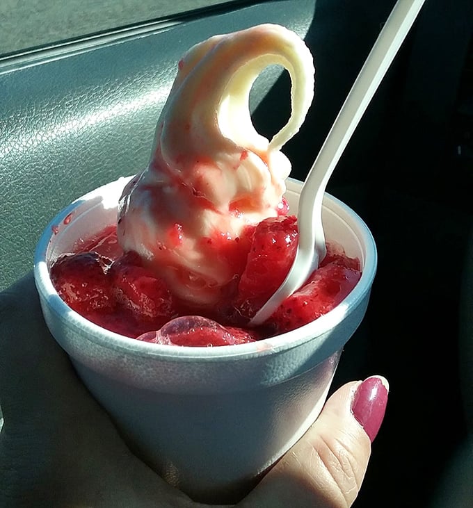 This strawberry sundae isn't messing around—that curl on top is the ice cream equivalent of showing off, and I'm here for it.