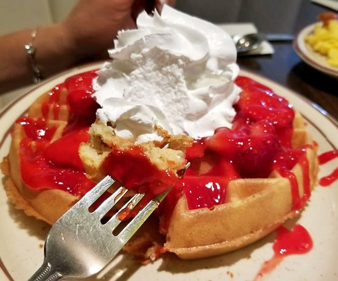 These strawberry waffles aren't just breakfast—they're dessert with an alibi. That whipped cream mountain isn't fooling anyone.