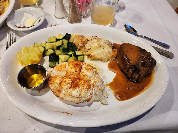 Surf meets turf in perfect harmony—lobster and filet mignon share the spotlight with fresh zucchini in a culinary performance worth applauding.