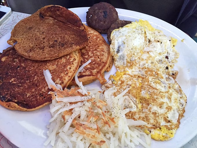 Breakfast alchemy at its finest: sweet potato pancakes sharing plate space with eggs and hash browns—a morning trilogy that rivals Lord of the Rings for epic satisfaction.