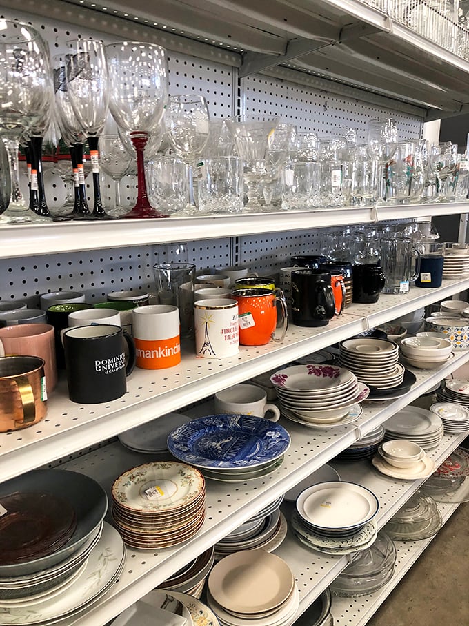 Crystal goblets neighbor everyday mugs while eclectic plates await new dinner tables. Someone's wedding registry rejects become your entertaining essentials.