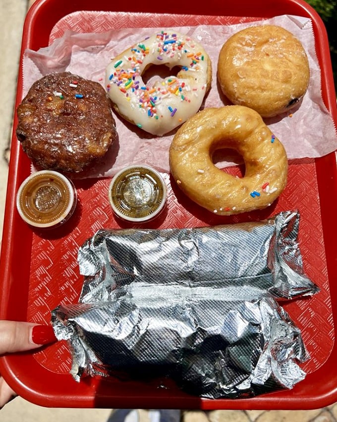 The breakfast tray of champions – donuts for your sweet tooth, tacos for your soul, and salsas to wake up your taste buds.
