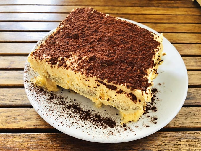 Tiramisu that could make an Italian grandmother weep with joy. The cocoa dusting is generous because life's too short for stingy desserts.