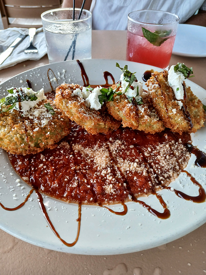 Fried green tomatoes with a crispy coating that shatters like glass, revealing the tangy treasure within. Southern poetry on a plate.