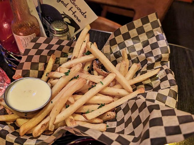 These aren't just fries—they're golden potato wands that have been blessed by the flavor gods and served in checkered paper.