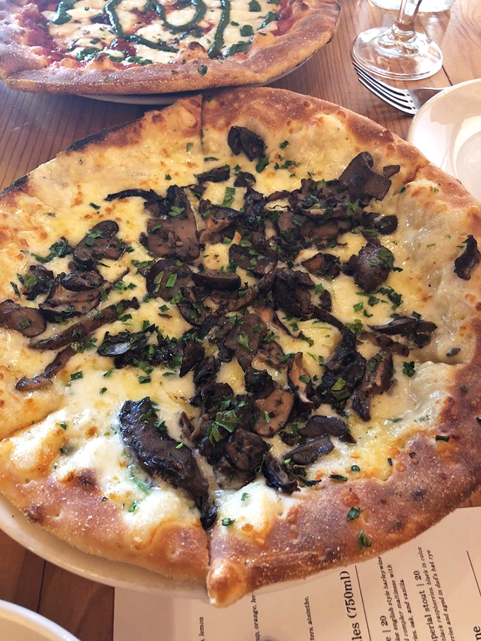 Mushrooms on pizza have never looked so sophisticated—earthy, umami-packed fungi nestled on a perfectly charred crust.