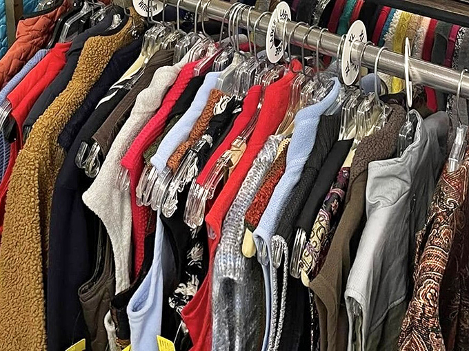 A rainbow of textures and colors hangs neatly on the rack. Each garment tells a story and waits for its next chapter.