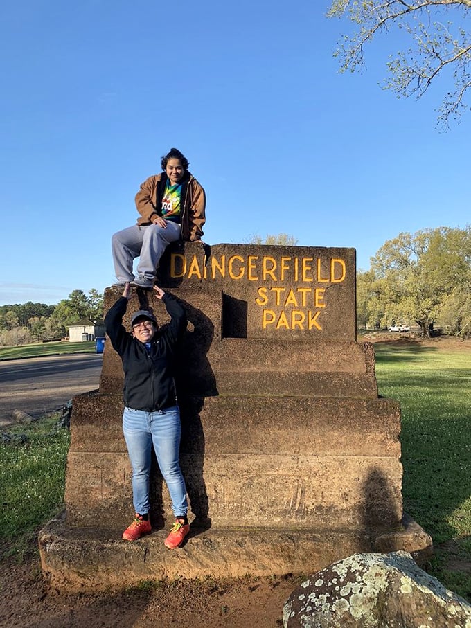 The park entrance sign doubles as the perfect photo op. Some landmarks practically demand a human pyramid, don't they?