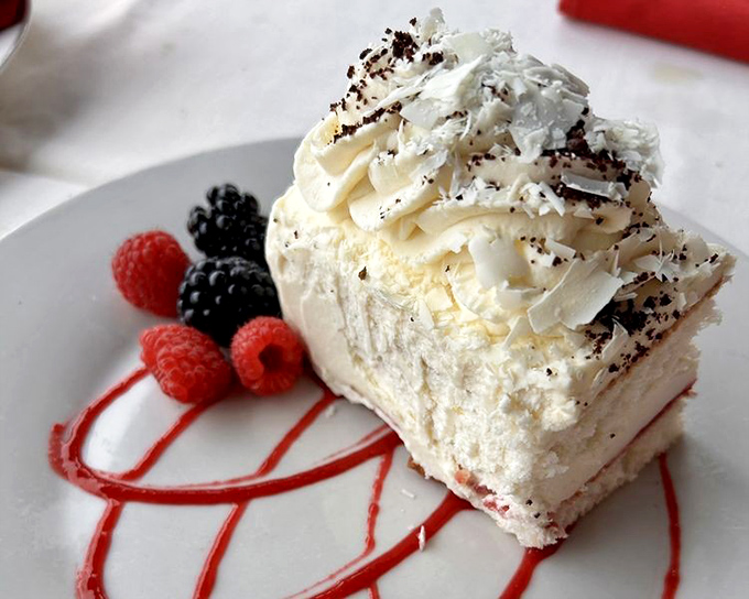 This white chocolate mousse cake with fresh berries isn't just dessert—it's what clouds would taste like if they went to culinary school.