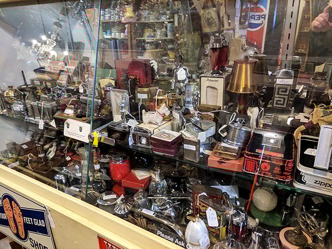 Behind glass, yesterday's necessities become today's collectibles—lighters, cameras, and gadgets that once represented the height of innovation.