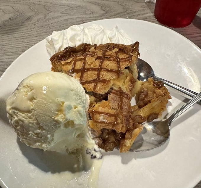 Apple pie with ice cream melting alongside—the kind of dessert that makes you temporarily forget every fancy pastry you've ever encountered.