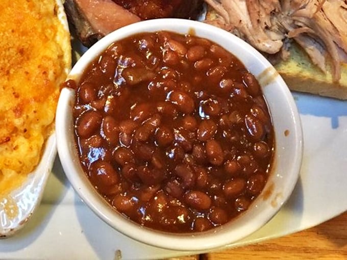 Molasses-infused baked beans studded with smoky meat bits – proof that even the humblest side dish can achieve greatness in the right hands.