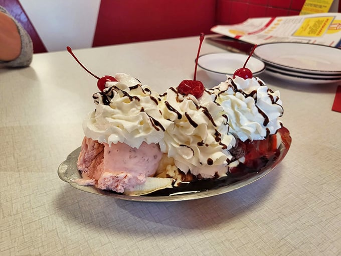 This banana split isn't just dessert, it's performance art – a symphony of ice cream, whipped cream, and cherries that makes adults remember what joy tastes like.