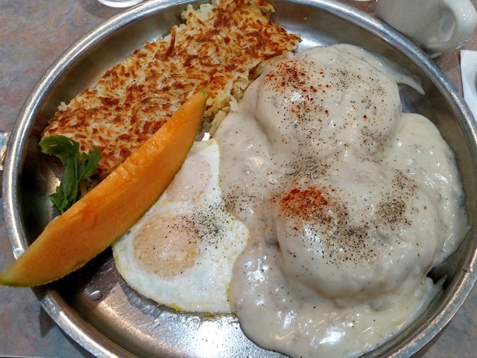 A skillet breakfast that's essentially breakfast's greatest hits album—crispy hash browns, perfectly cooked eggs, and gravy that demands to be sopped up.