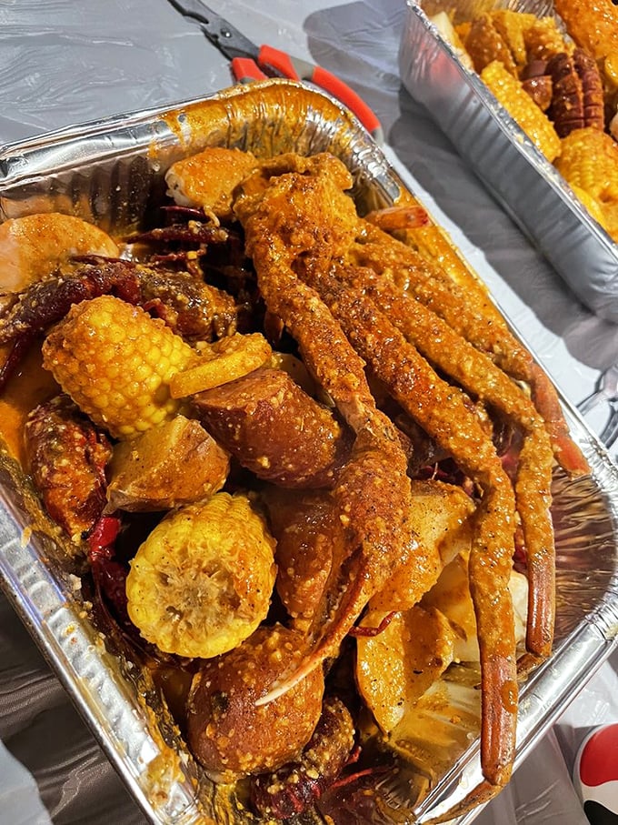 Seafood, corn, and potatoes swimming in spiced butter sauce—a beautiful mess that's worth every napkin. Plastic bibs become fashion statements here.