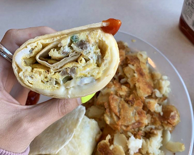 Breakfast engineering at its finest—this wrap reveals layers of fluffy eggs, melted cheese, and savory fillings that put ordinary breakfast sandwiches to shame.