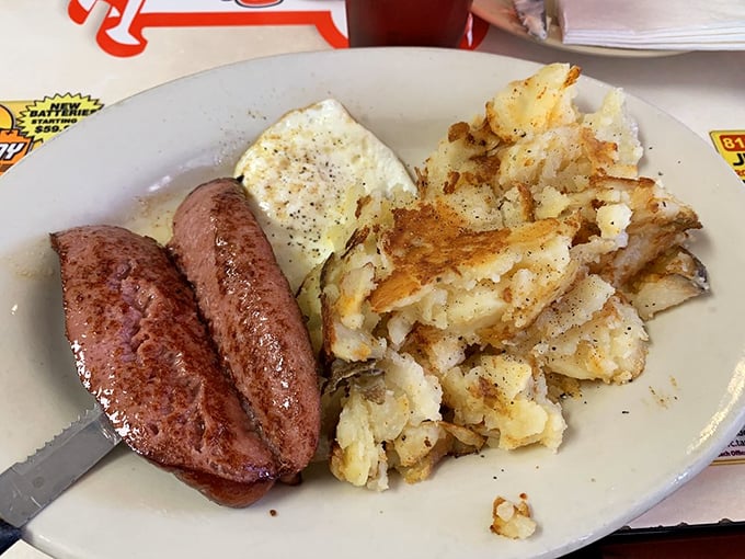 Sausage links, grits, eggs, and biscuits smothered in gravy—a breakfast platter that says "go back to bed" and "conquer the world" simultaneously.
