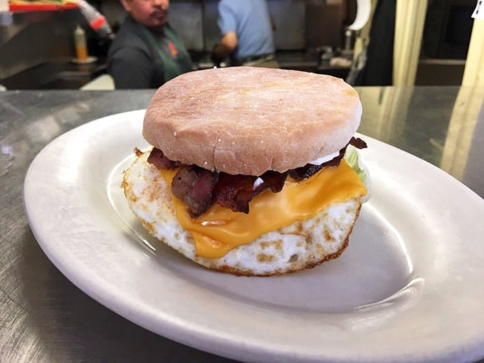 The breakfast sandwich—an architectural marvel of egg, cheese, and bacon on an English muffin. Portable perfection that makes fast food chains weep with inadequacy.