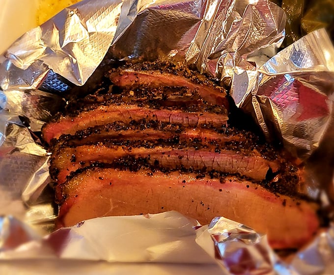 Brisket so perfectly smoked it practically tells a story – each slice revealing that telltale pink ring that whispers, "I was made with patience."
