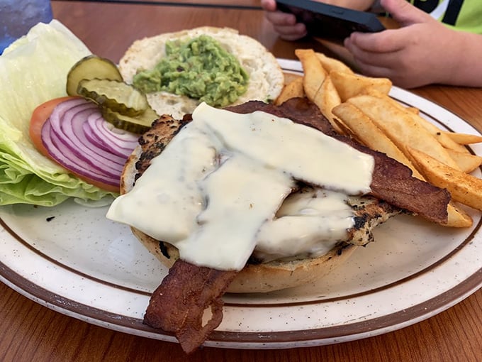 This isn't just a chicken sandwich – it's architecture with avocado, where melty cheese cascades over perfectly grilled chicken like a dairy waterfall.