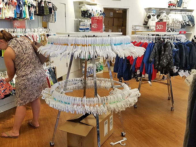 Tiny hangers holding tinier clothes that cost less than your morning latte – parenting just got easier.