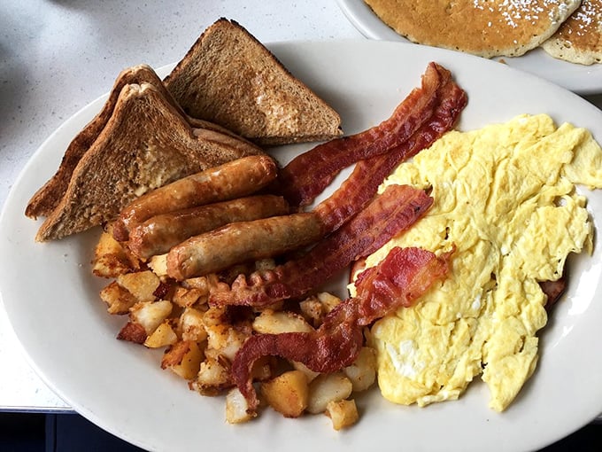 The classic American breakfast trifecta—eggs, meat, and toast—executed with the precision of a breakfast symphony conductor.