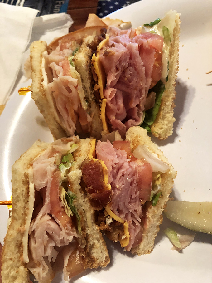This club sandwich isn't messing around—stacked higher than your weekend plans and packed with enough meat to feed a small family.