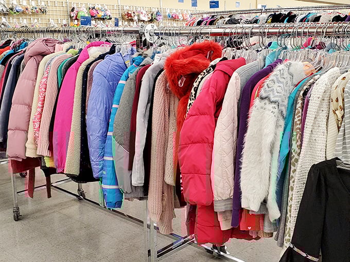Winter coats hanging like colorful cocoons, waiting to transform someone into their coziest self.