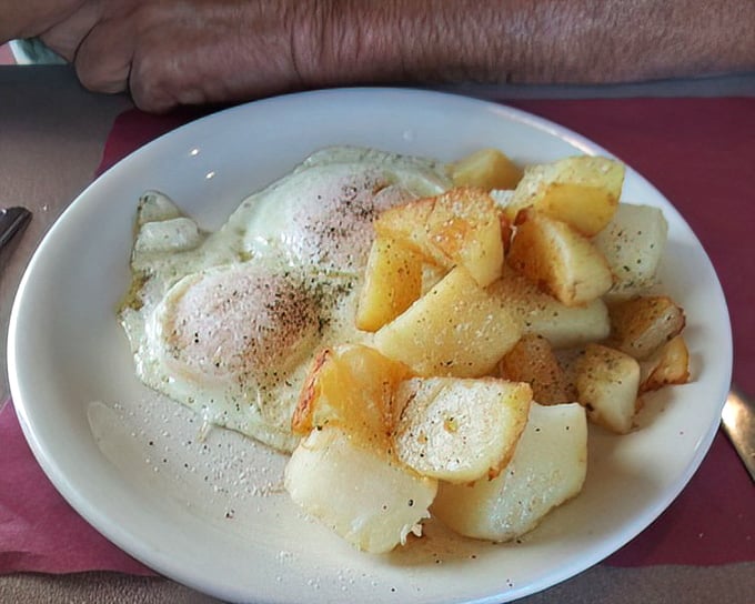 Sunny-side up eggs with home fries—the breakfast equivalent of a perfect day where nothing goes wrong and everything tastes right.