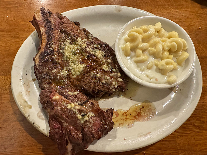 This cowboy ribeye with mac and cheese proves that sometimes the perfect dining companion isn't a person, but a side dish.