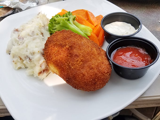 The legendary crab cake—more crab than cake, as it should be—served with sides that know their supporting role and play it perfectly.