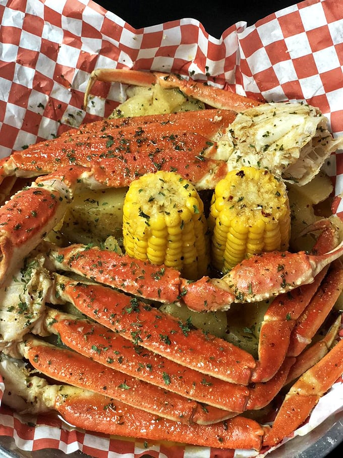 Crab legs splayed like a crustacean sunbather, glistening with herb-flecked butter. This is what seafood dreams are made of—sweet meat waiting to be discovered. 