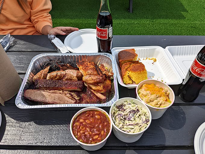 The full barbecue experience, complete with sides and Mexican Coke—proof that happiness can indeed be packed in takeout containers.