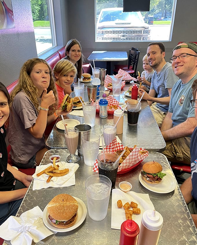 Family memories are made around these tables, where multiple generations bond over the shared experience of burger-induced food comas.