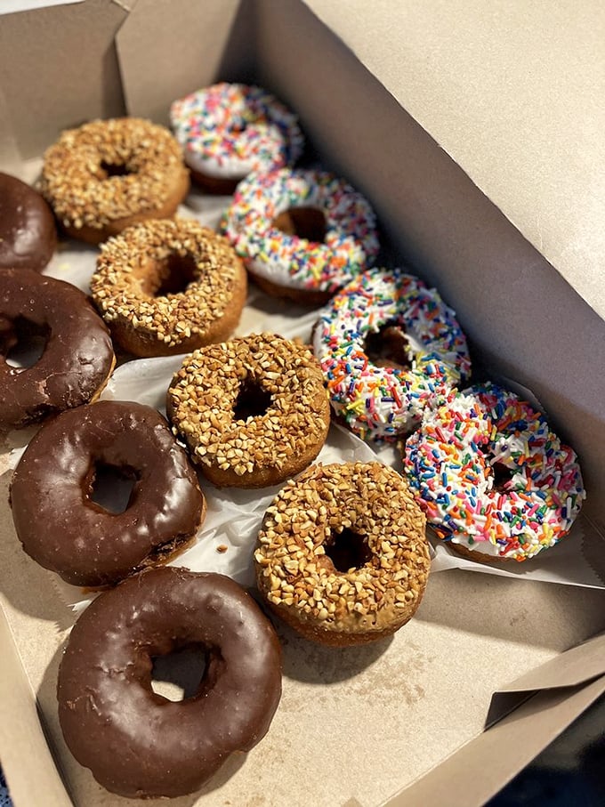 The donut box—where good intentions about "just having one" go to die amid a rainbow of frosting and sprinkles.