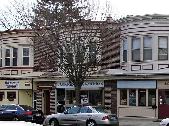These classic storefronts along Broadway house local businesses where your dollar still commands respect—unlike those trendy neighborhoods where coffee costs more than gasoline.
