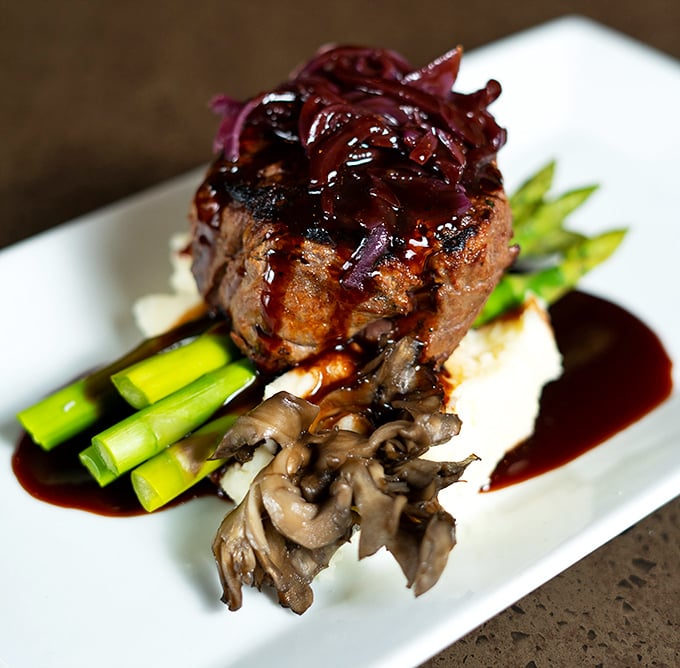 This filet mignon isn't just dinner—it's a special occasion on a plate. The asparagus spears stand at attention, knowing they're in good company.
