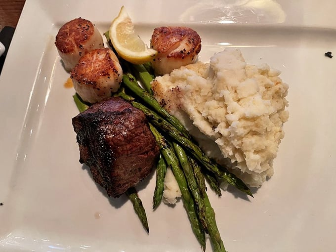 The perfect marriage: tender filet mignon meets buttery potato and grilled asparagus. This plate doesn't need Instagram filters—it's already the supermodel of steakhouse classics.