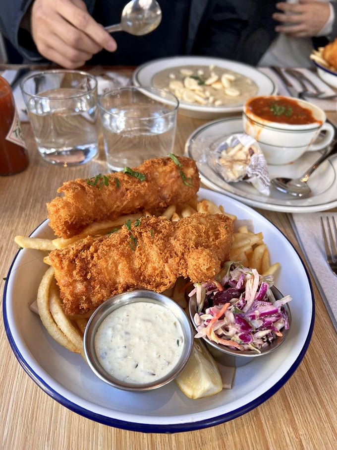 Fish and chips that would make a British pub proud—golden armor protecting flaky white fish, with tartar sauce standing by for dunking duty.