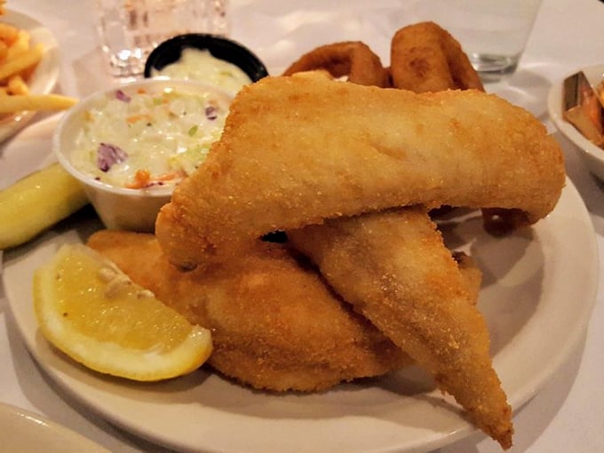 Wisconsin's fish fry tradition at its finest – crispy, golden perfection with creamy coleslaw that makes Friday feel like a celebration.