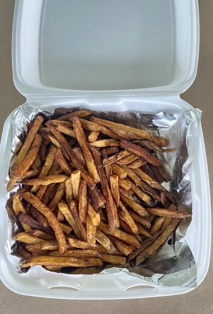 Hand-cut fries with personality—crispy, irregular, and perfectly imperfect. The kind that make frozen versions weep with inadequacy.