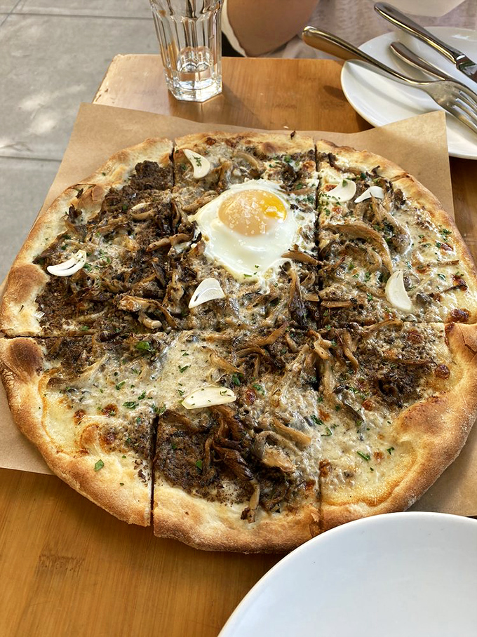 The funghi pizza—where mushrooms throw the party of the year and a farm egg gets the VIP treatment in the center.