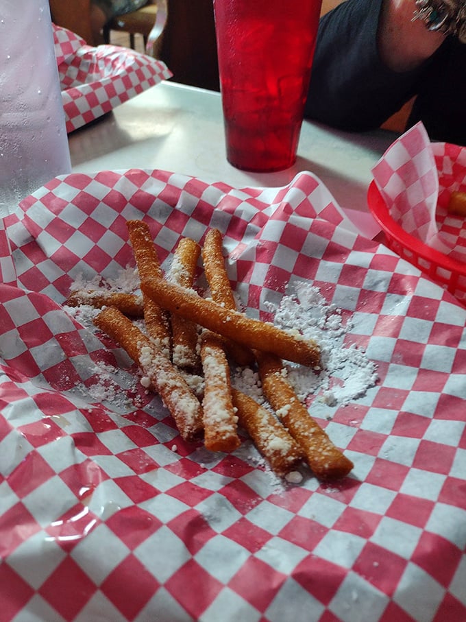 Funnel cake fries dusted with powdered sugar—where carnival indulgence meets everyday possibility, proving dessert is always a good idea, especially in Mississippi.